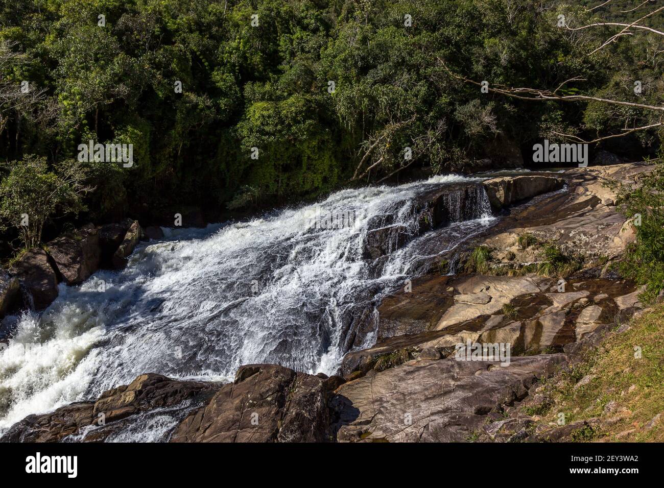 A beautiful view of a waterfall streaming down the rocky mountain in ...