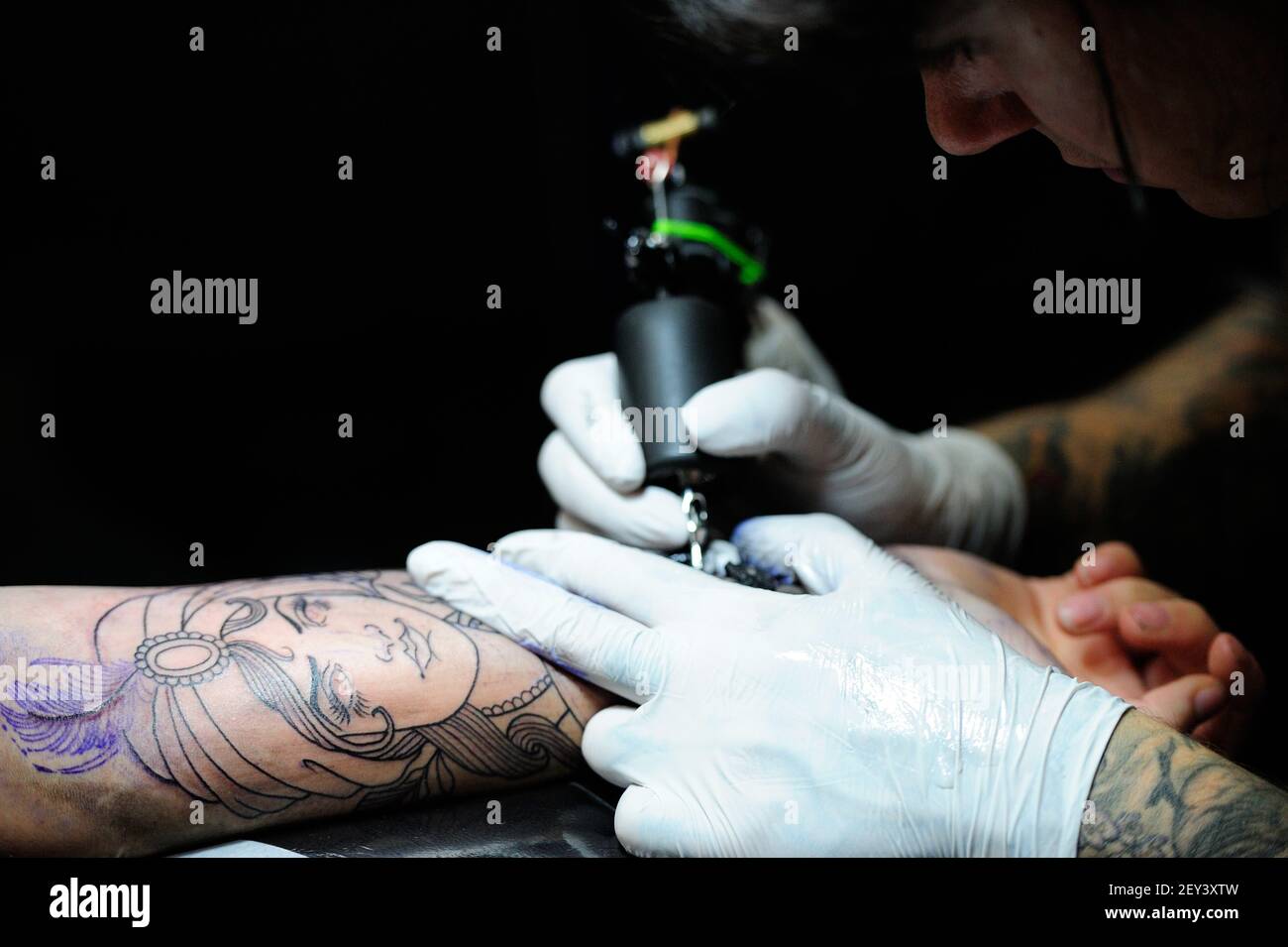 A girl is tattooed by Gin Hicks of Icon Tattoo at the 6th Annual ...