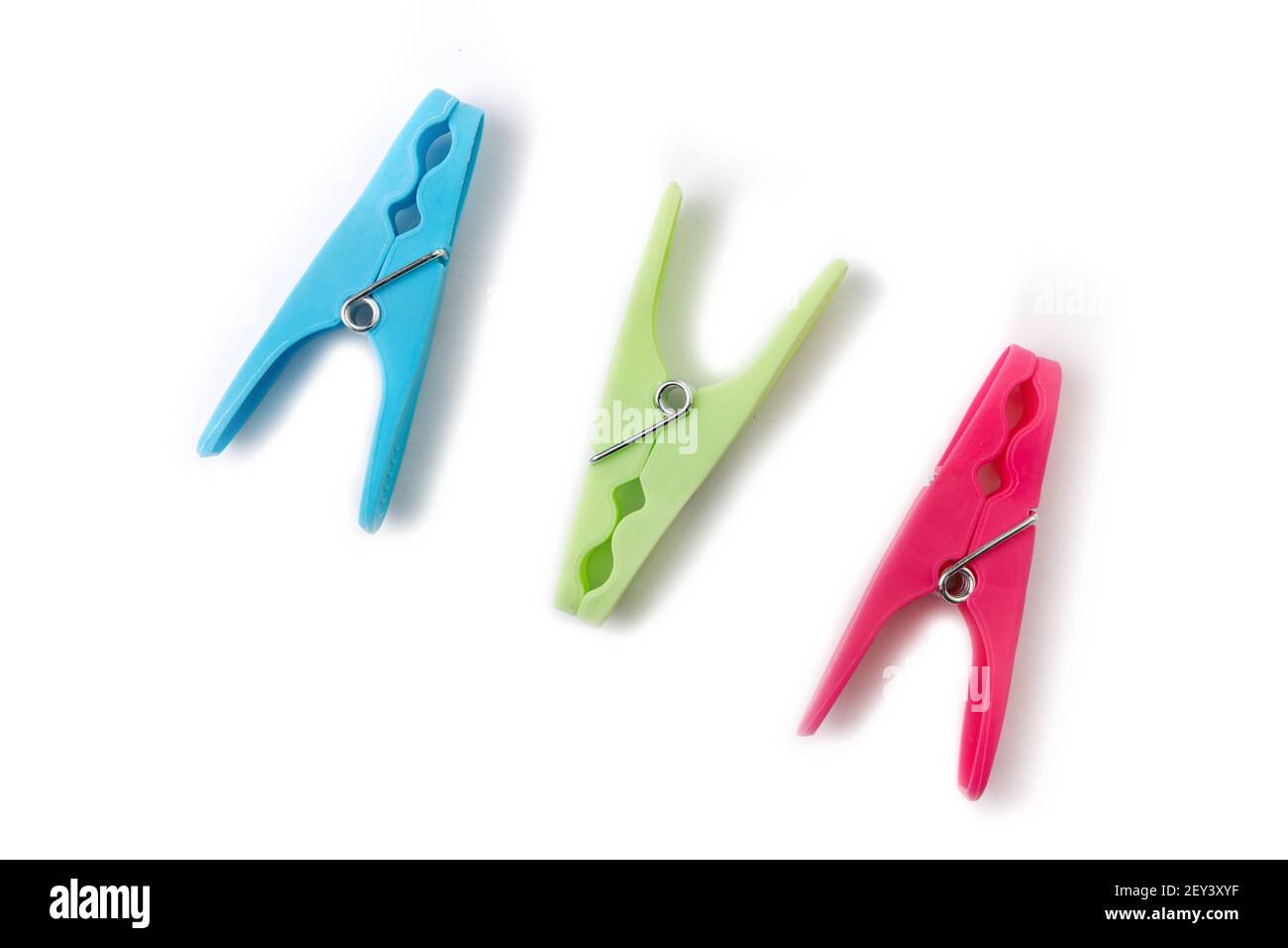top view of three different color clothespins isolated on white ...