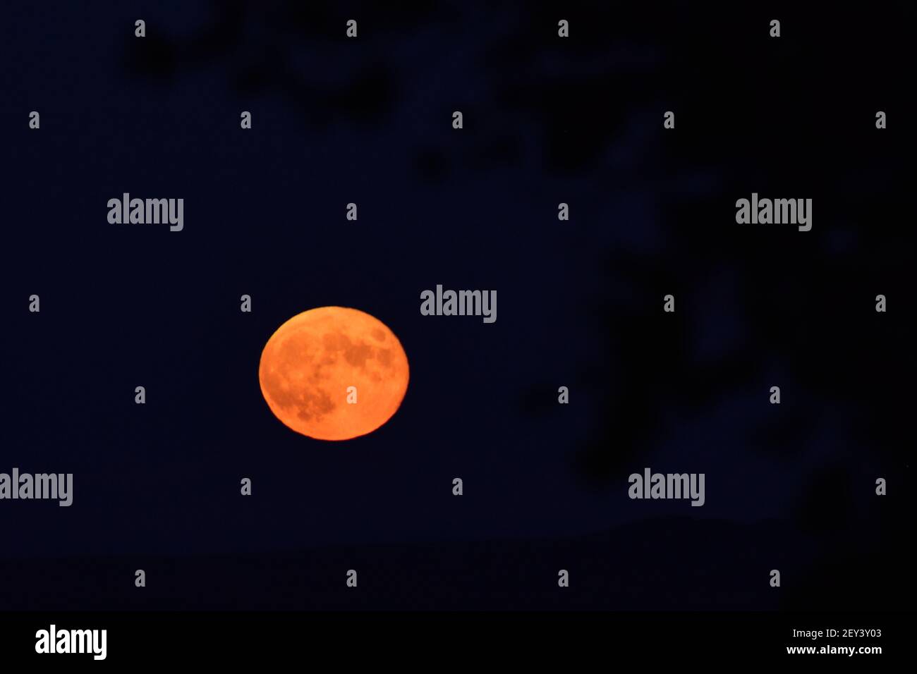 A 99% waning gibbous moon rises over the horizon on October 8, 2014 ...