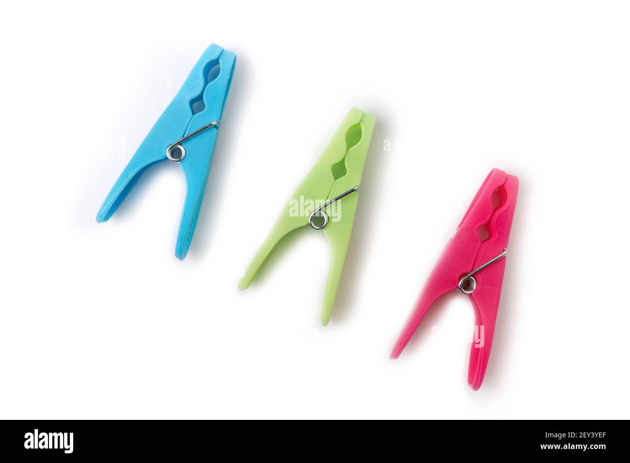 top view of three different color clothespins isolated on white ...