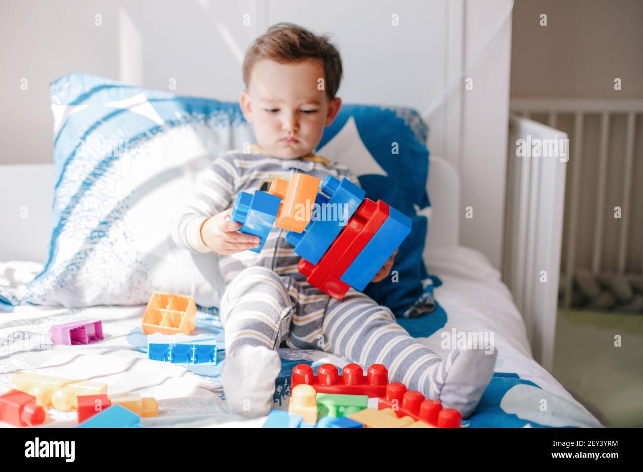 Cute baby toddler playing building with learning toy stacking blocks at ...