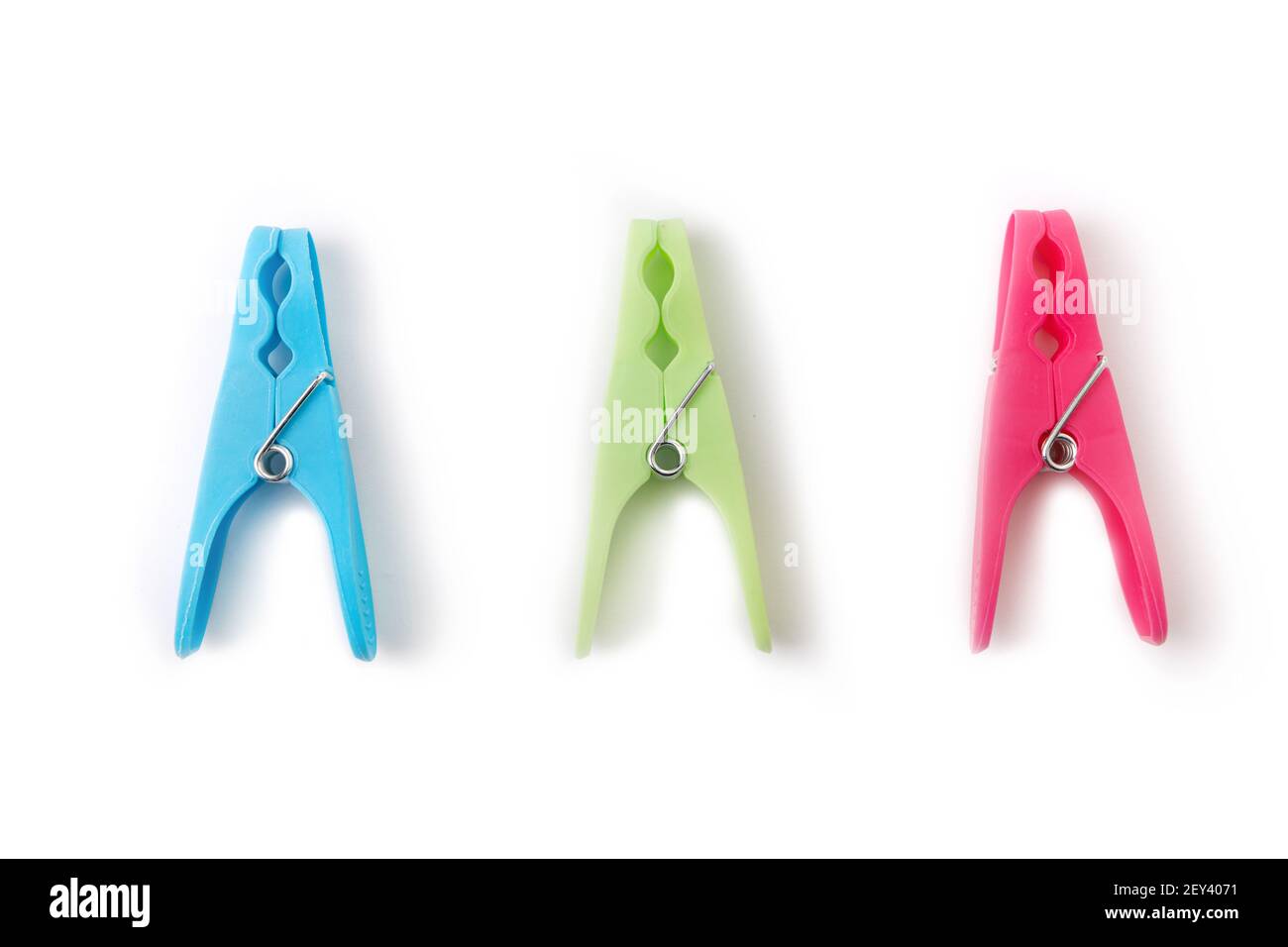 top view of three different color clothespins isolated on white ...