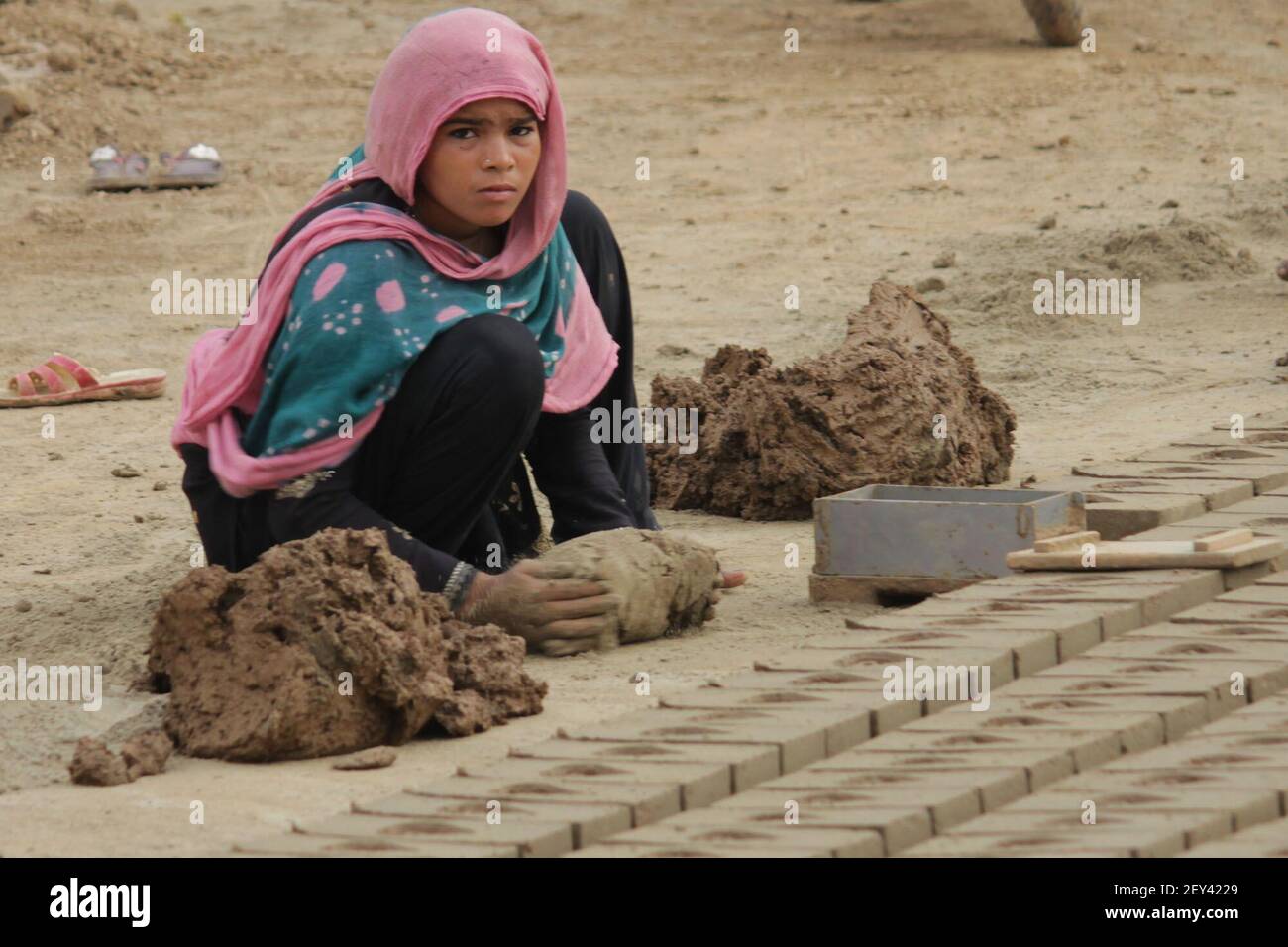 Pakistani women make bricks in Lahore, Pakistan on October 14, 2014 ...