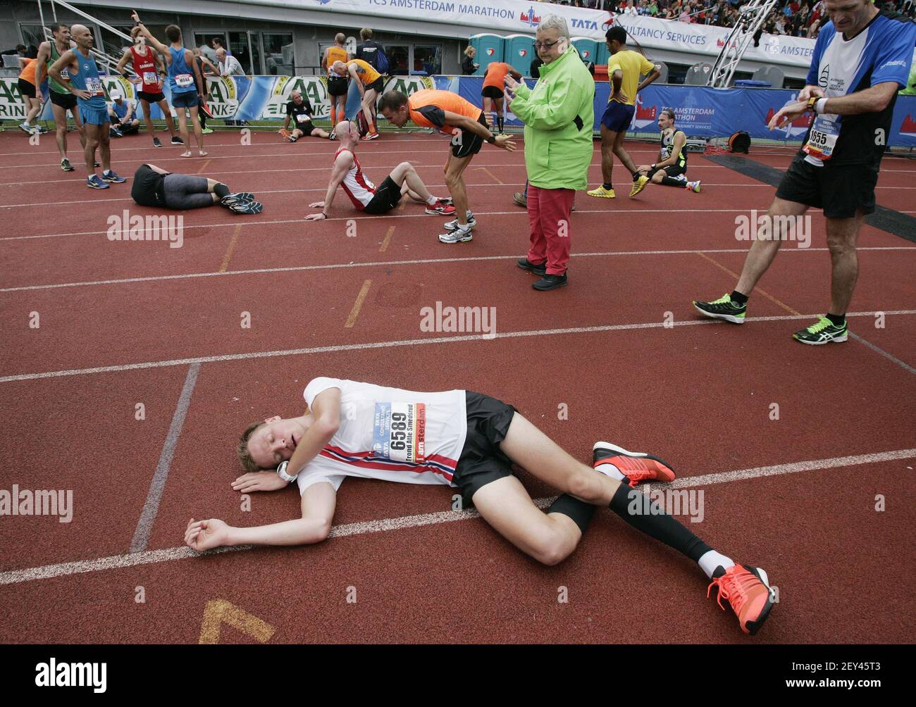 Runners reacts after crosses the finish line to win the Amsterdam ...
