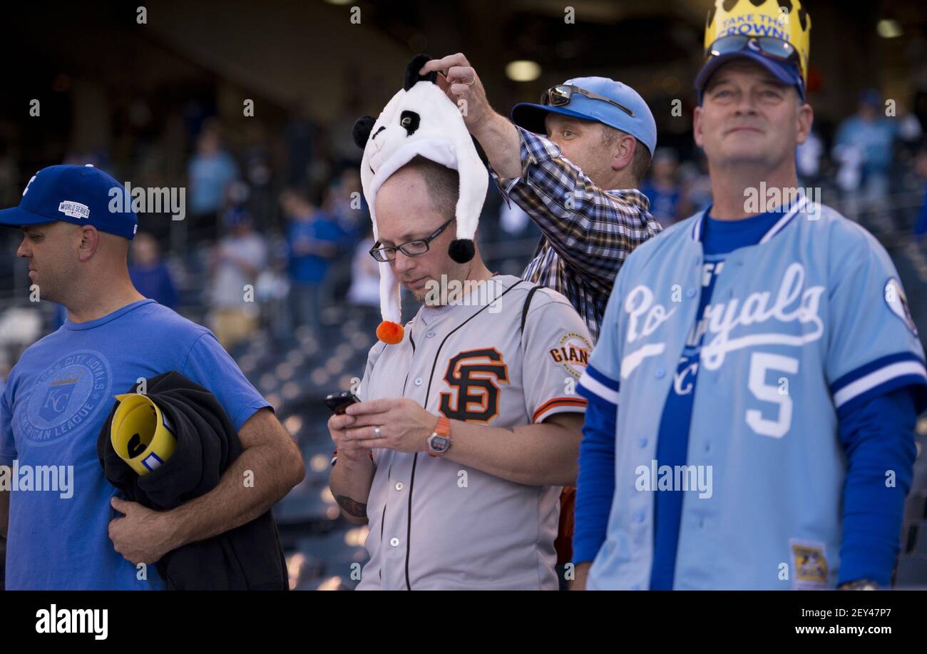 Kansas City Royals fan Todd Leach playfully removes the Panda hat of ...