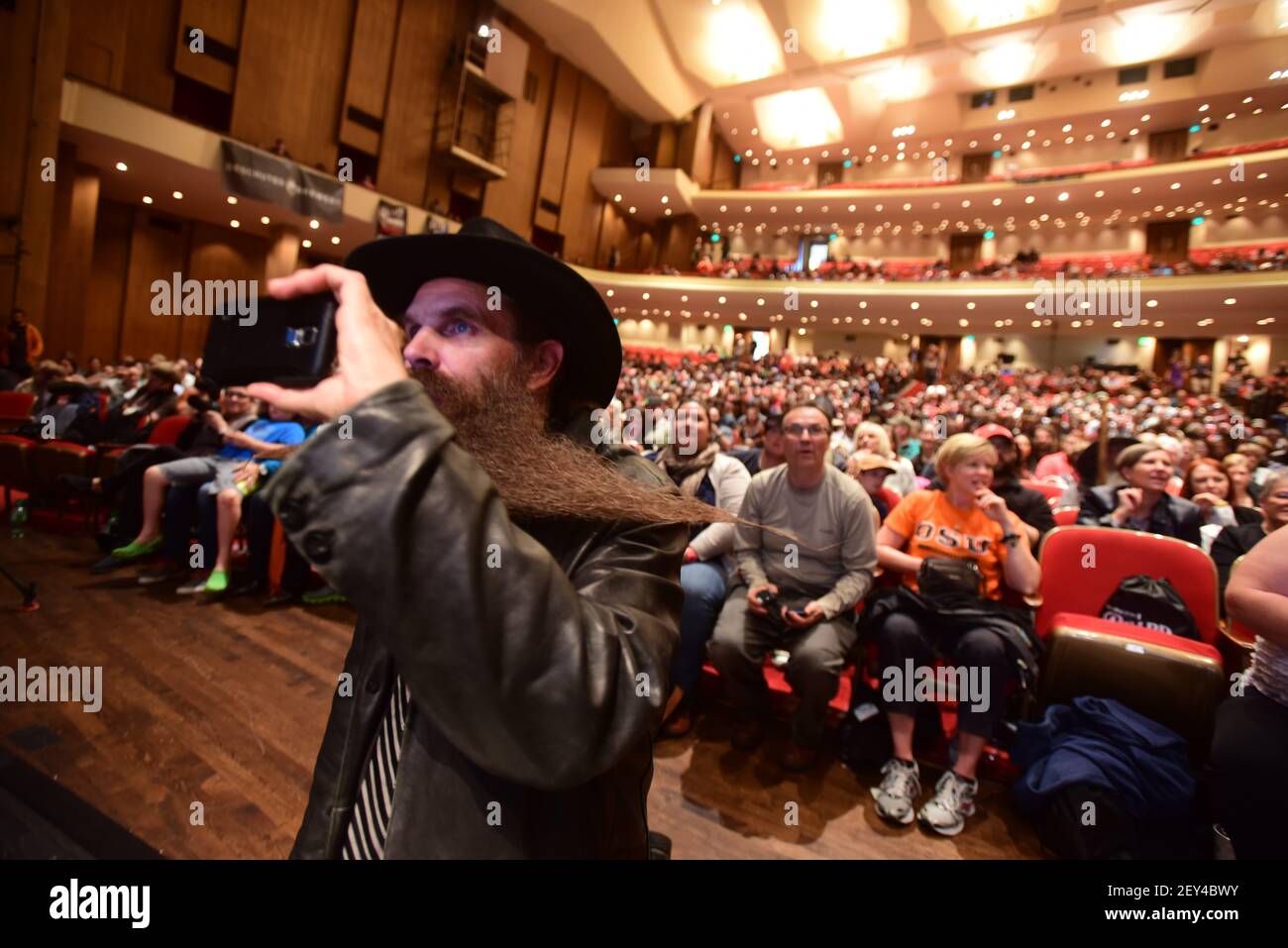 A man films the action as people compete in the World Beard and ...