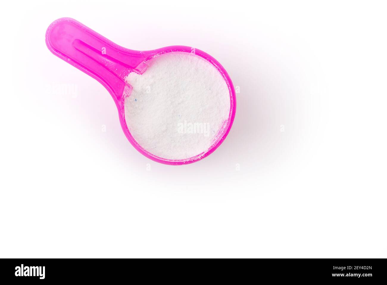 top view of washing powder in pink measuring spoon isolated on white ...