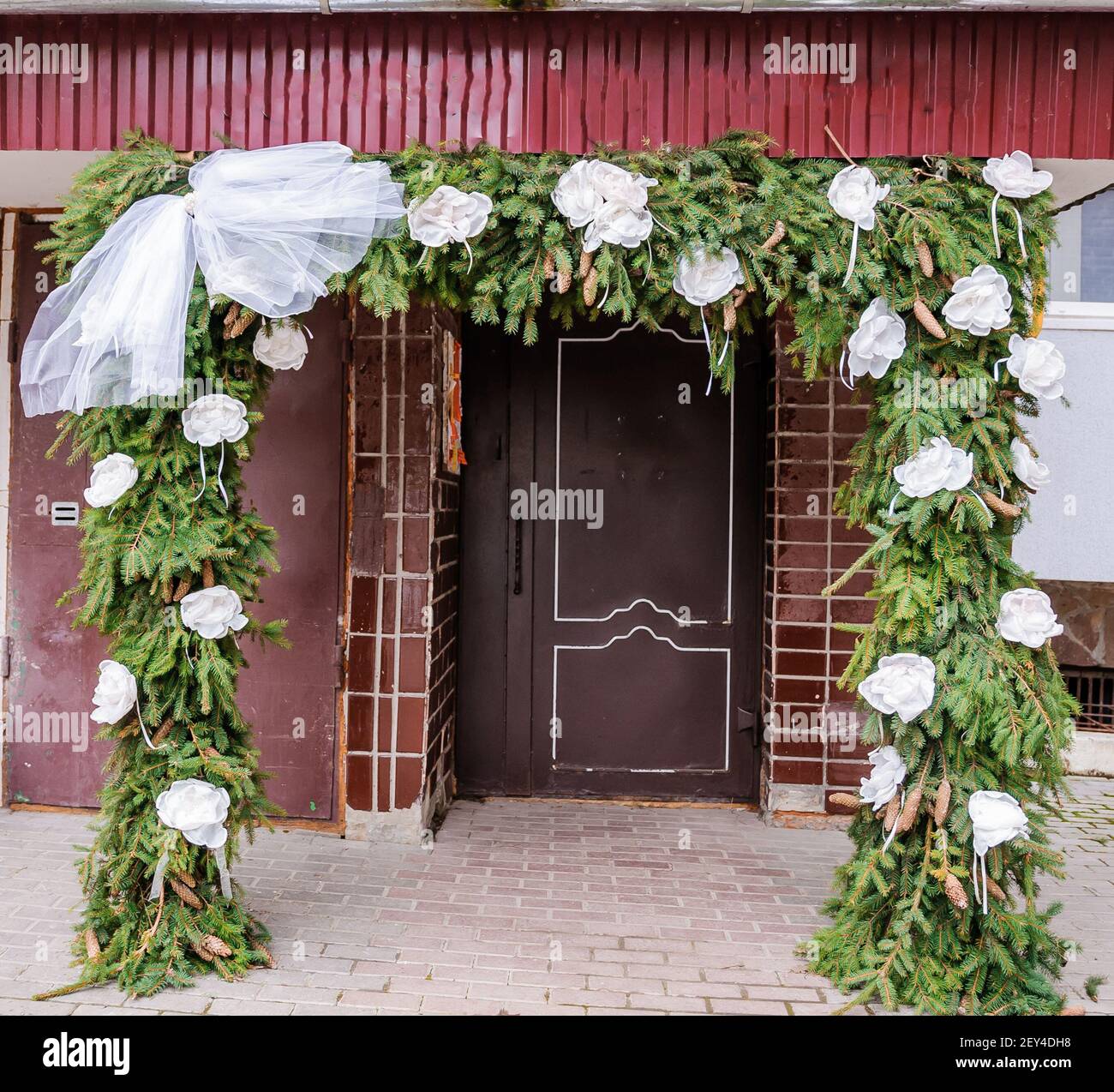 Wedding arch made of spruce, flowers and balloons Stock Photo - Alamy