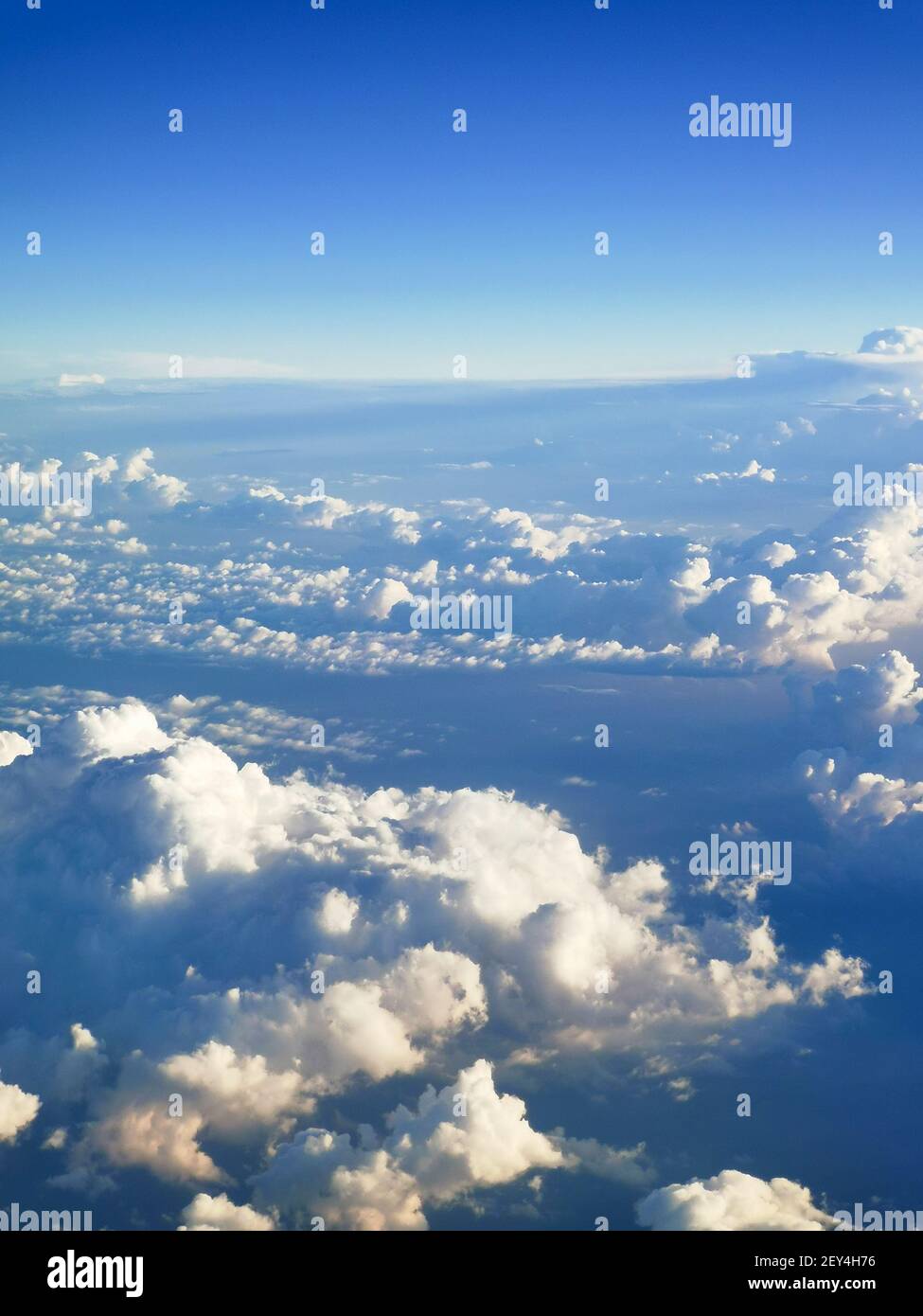 A beautiful view from an airplane on white voluminous fluffy clouds ...