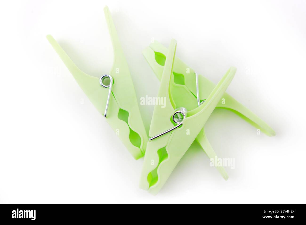 top view of grreen clothespins on white background Stock Photo - Alamy