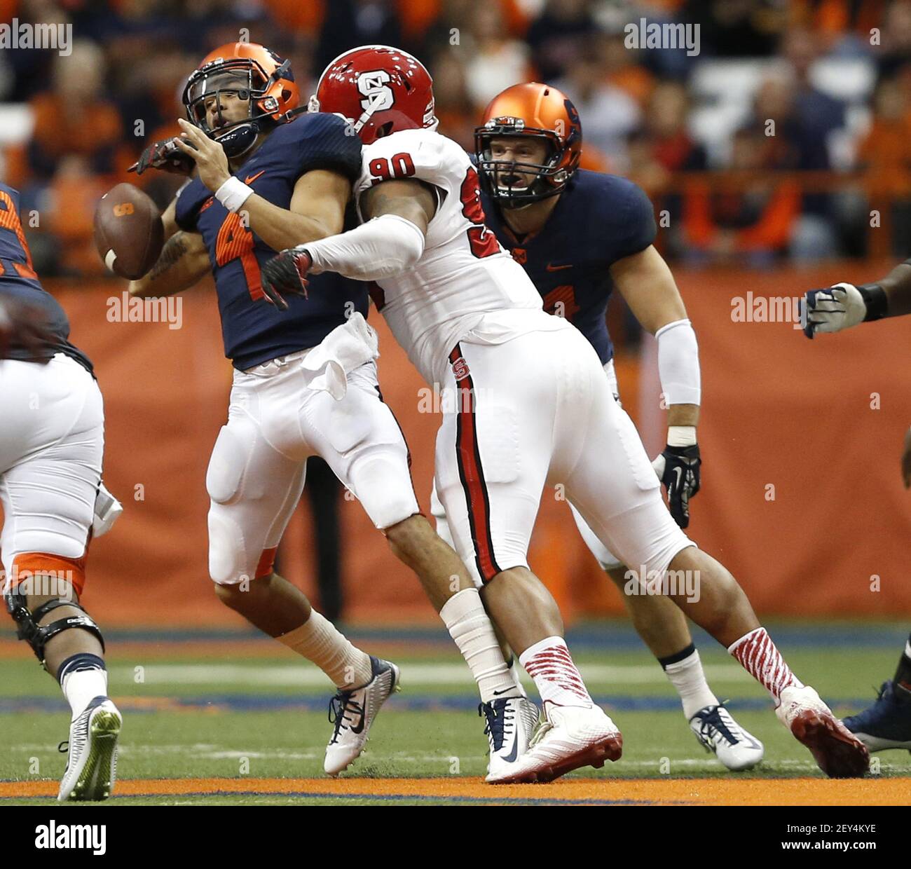 N.C. State defensive end Mike Rose (90) hits Syracuse quarterback AJ ...