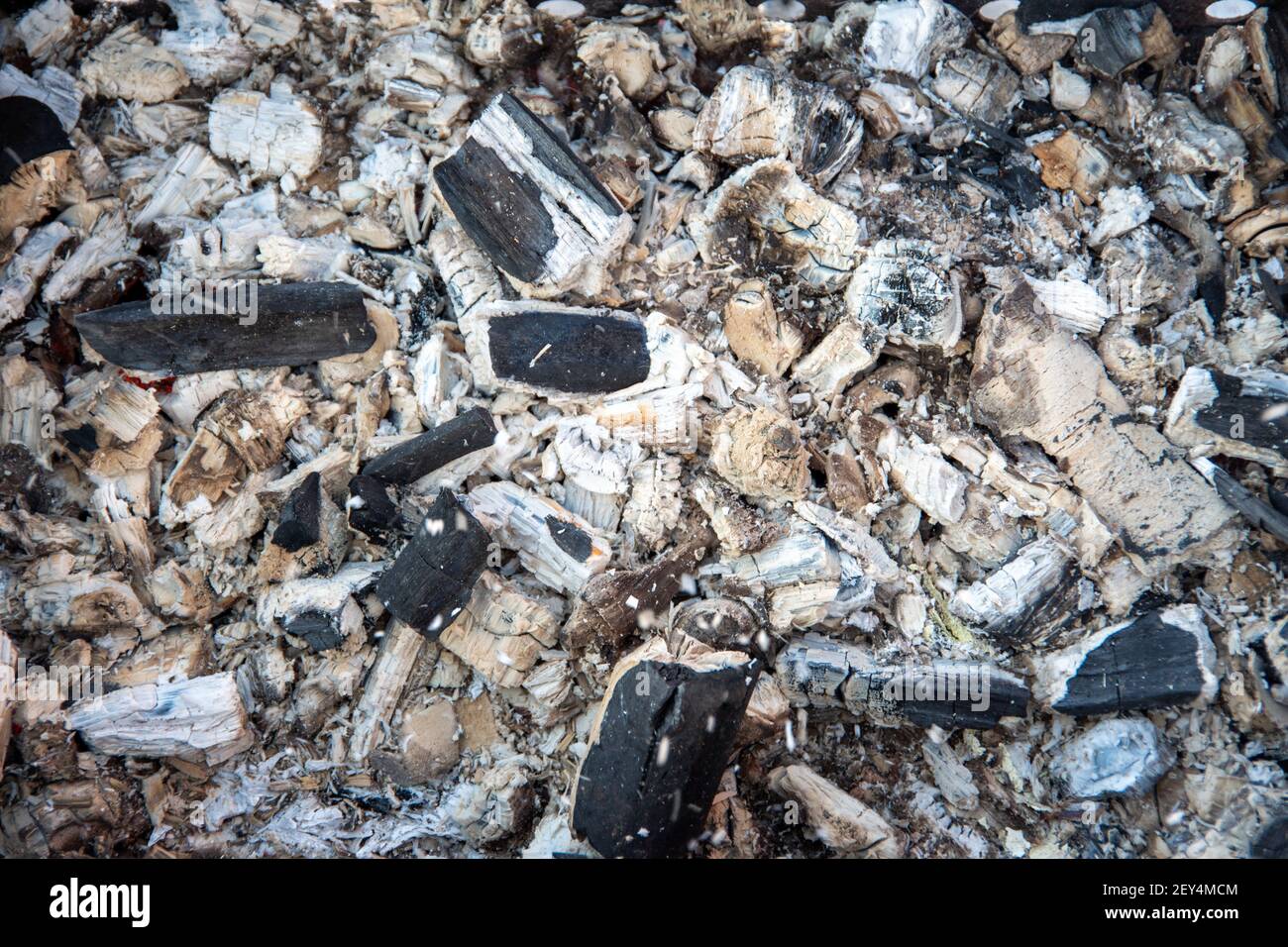 red-hot pieces of coal and flame in a roasting pan for cooking ...
