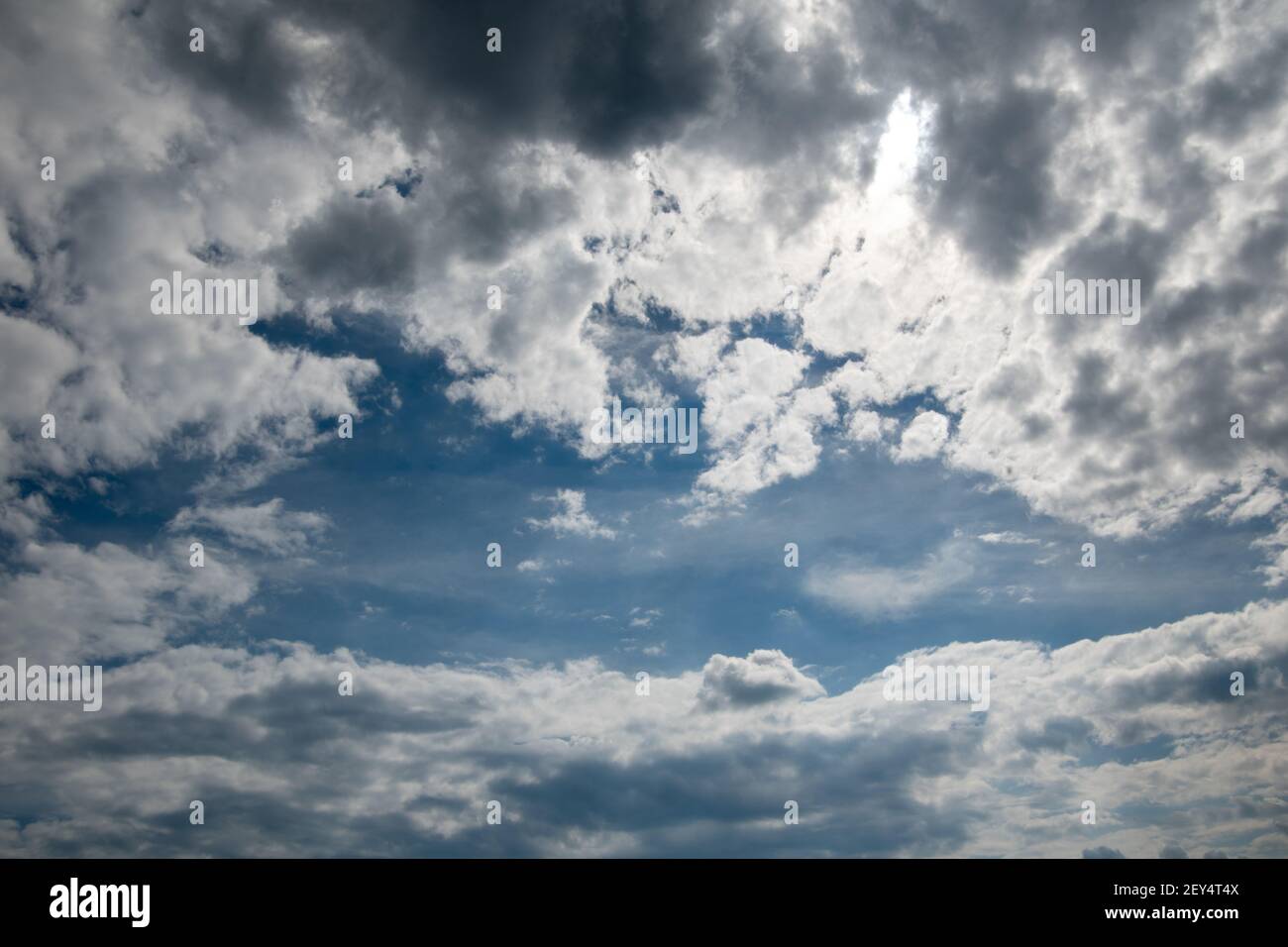 A huge cumulus cloud and many small clouds on a blue sky. Nature ...