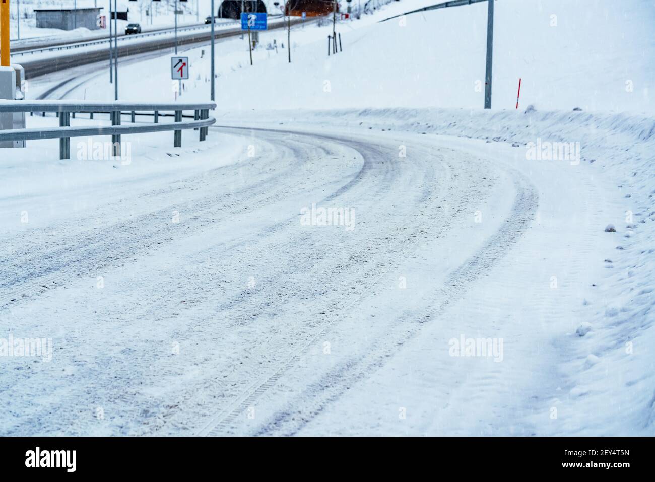 Icy snow covered road leading to a large highway. Close up of the ramp Stock Photo - Alamy