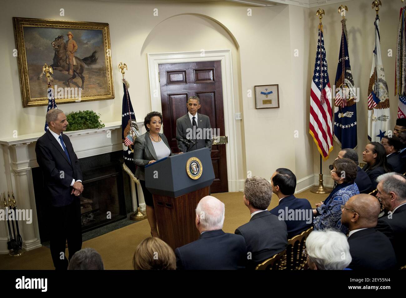 With Attorney General Eric Holder looking on, President Barack Obama ...