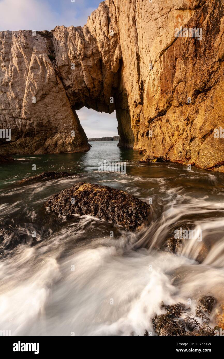 Bwa Gwyn sea arch near Rhoscolyn, Anglesey, North Wales Stock Photo - Alamy