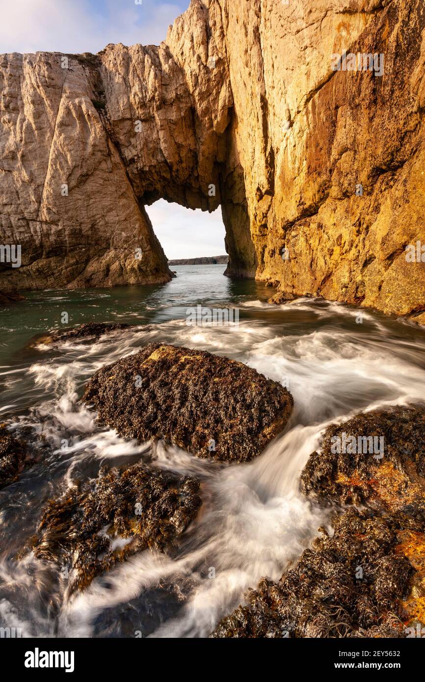 Bwa Gwyn sea arch near Rhoscolyn, Anglesey, North Wales Stock Photo - Alamy