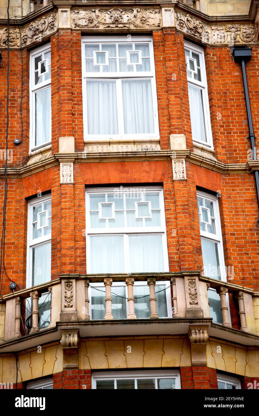 In europe london red brick historical window Stock Photo - Alamy
