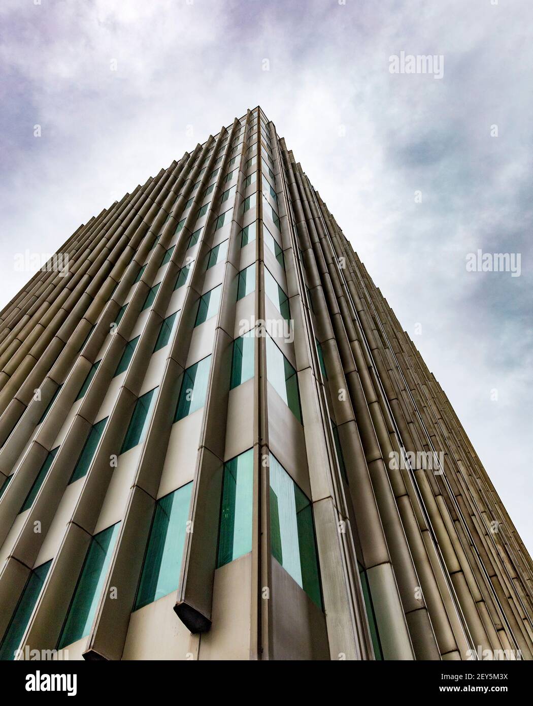 Modern facade with green windows and dramatic sky Stock Photo - Alamy