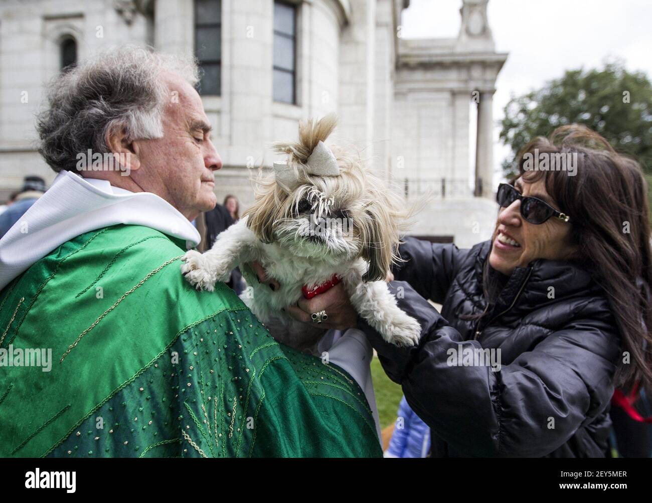 Jill Wolfe of Golden Valley hands her 13-year-old dog Chickie to Father ...