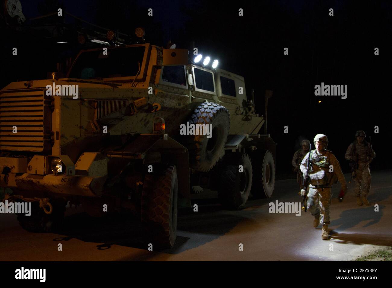 Soldiers from 1st Brigade Combat Team, 1st Cavalry Division walk past a ...