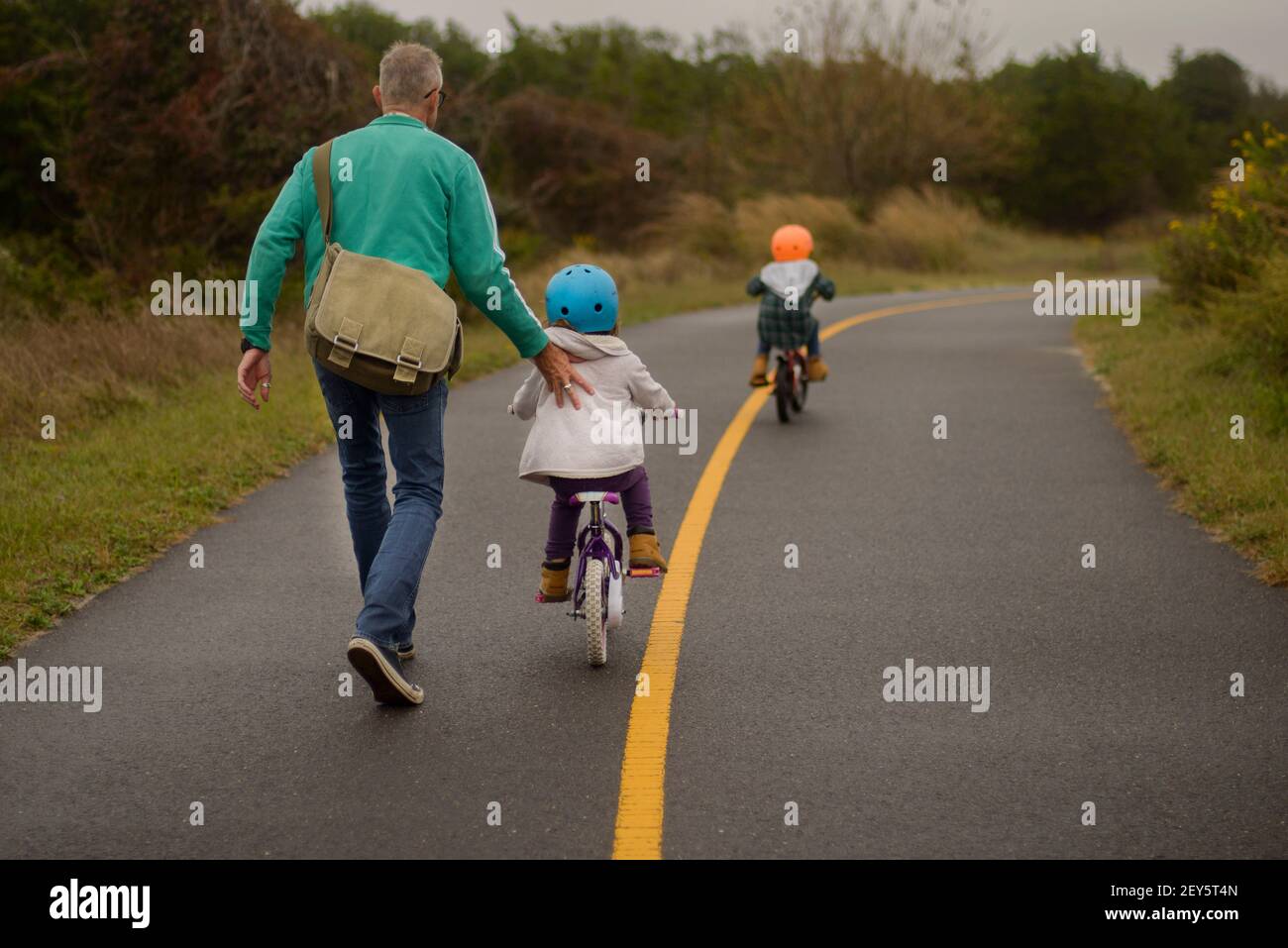 LEARNING TO RIDE A BIKE WITH DAD Stock Photo - Alamy