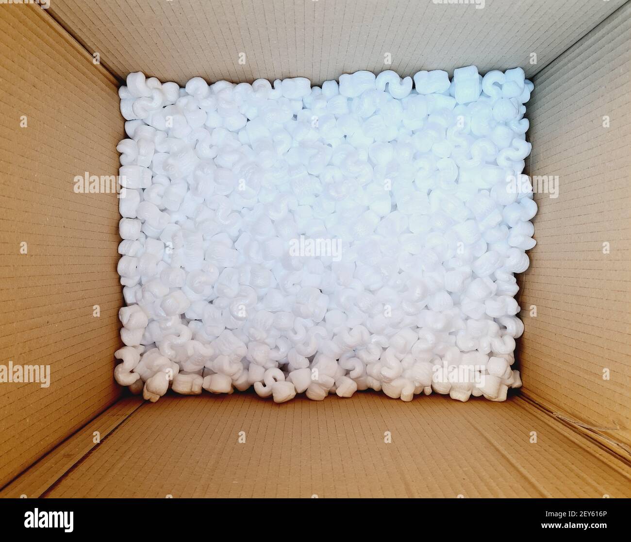 A top view of a huge box filled with thousands of s-shaped white ...