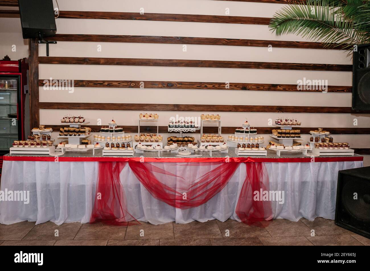 Sweet cakes at a wedding banquet. Catering, sweet festive buffet. Candy ...