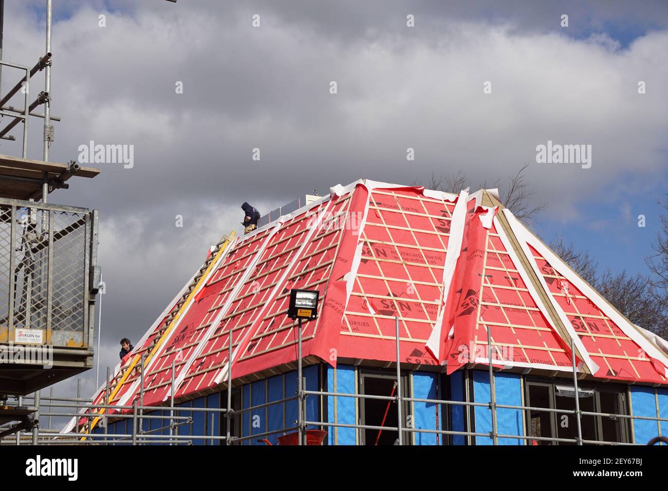 Scaffolding at a house currently under construction protected from the ...