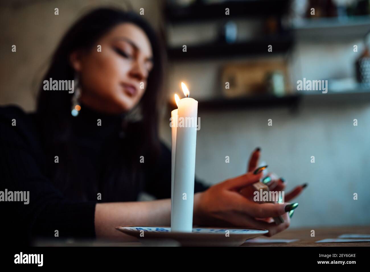 a fortune teller lights ritual candles to predict the future using ...