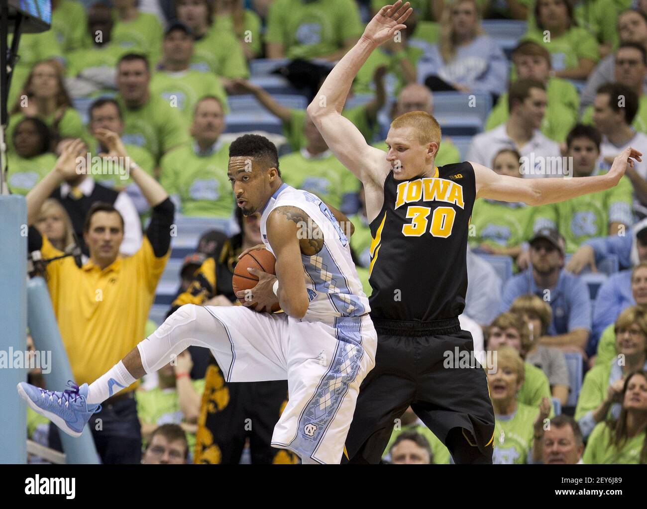 UNC's J.P. Tokoto (13) harnesses a defensive rebound from Iowa's Aaron ...