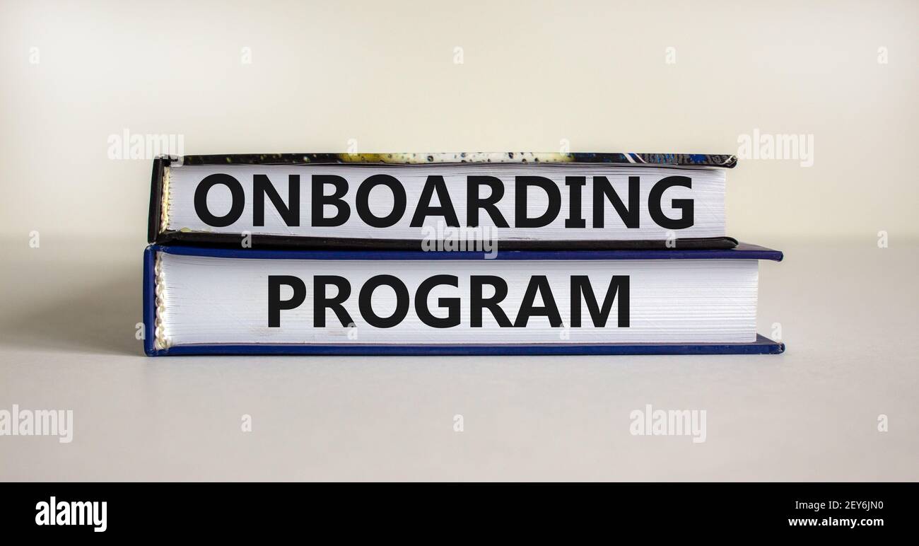 Onboarding program symbol. Books with words 'onboarding program' on ...