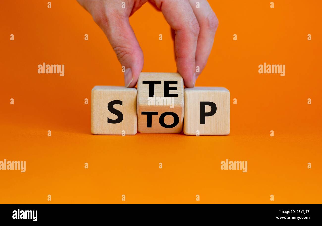 Stop or next step symbol. Businessman turns cubes and changes the word ...