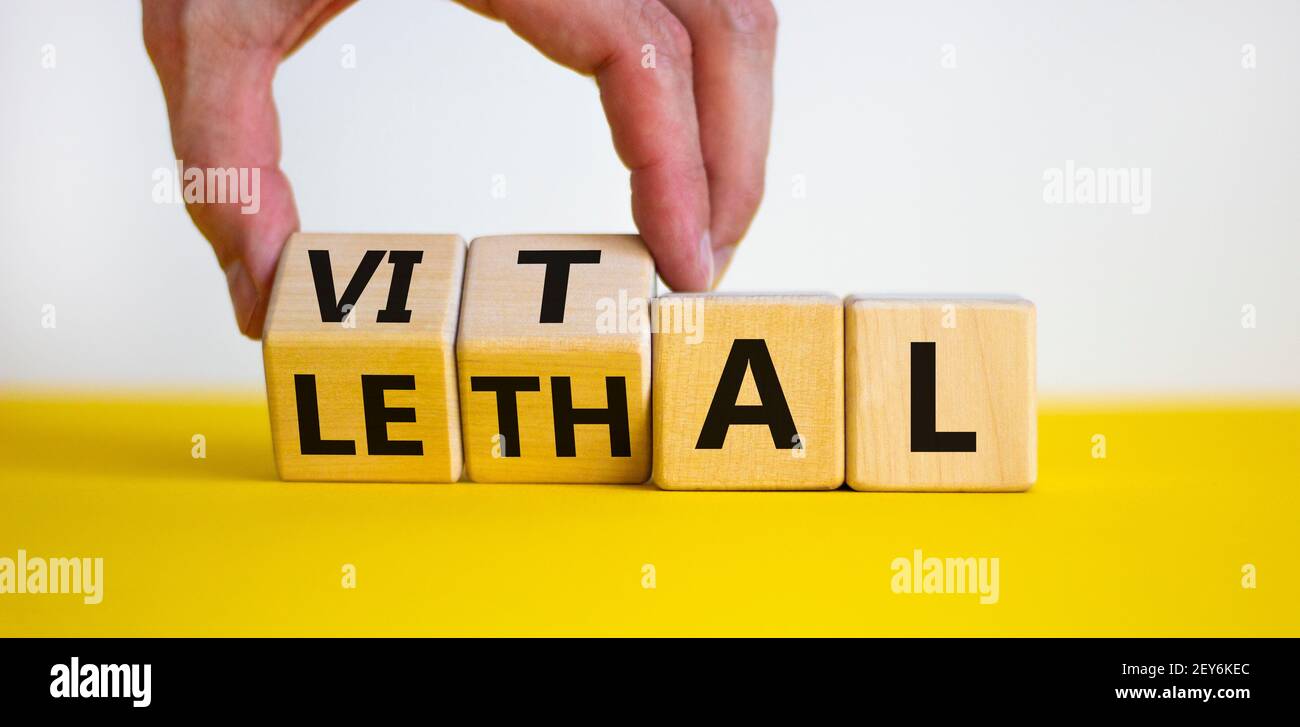 Vital vs lethal symbol. Businessman turns wooden cubes and changes the ...