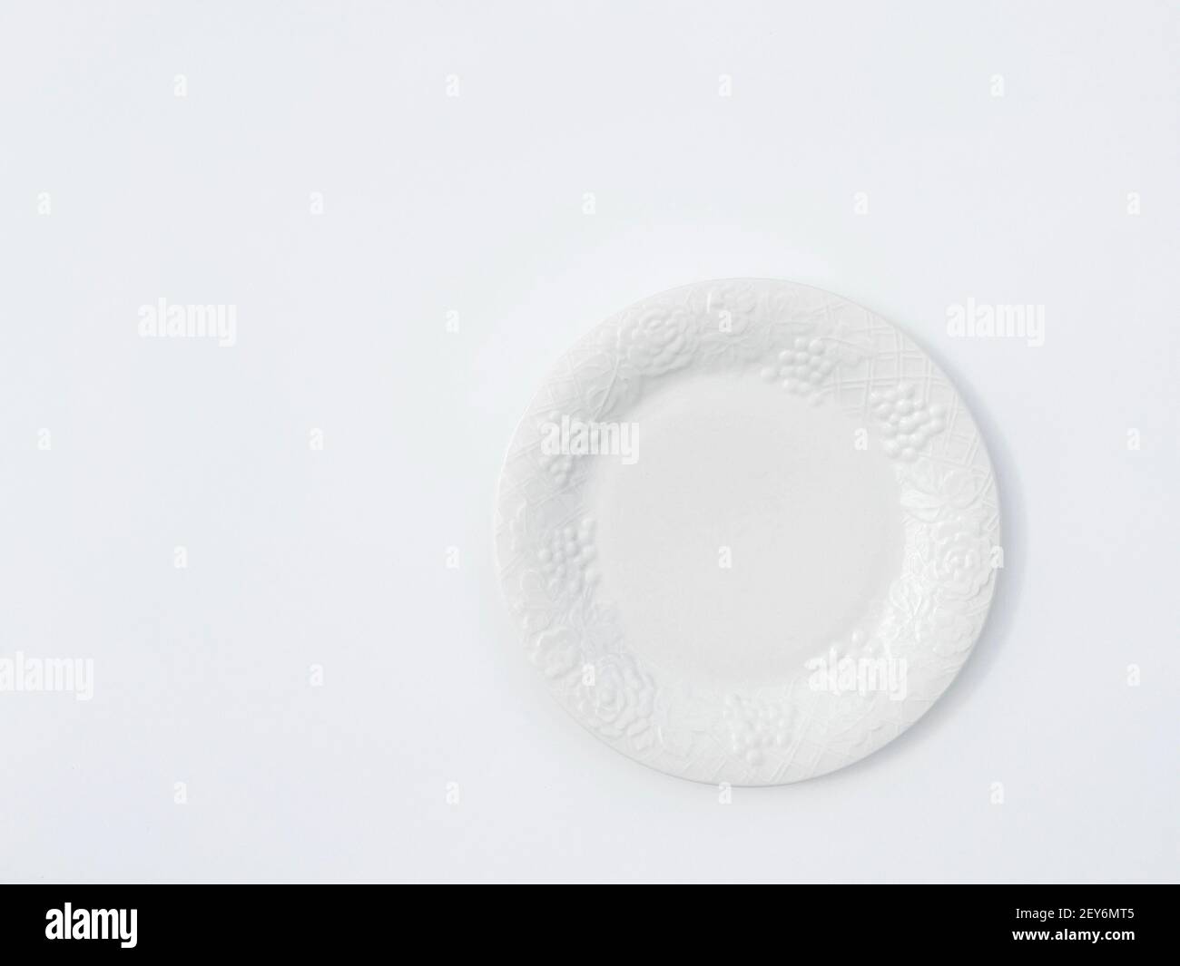 A top view of a white decorative plate isolated on white background ...