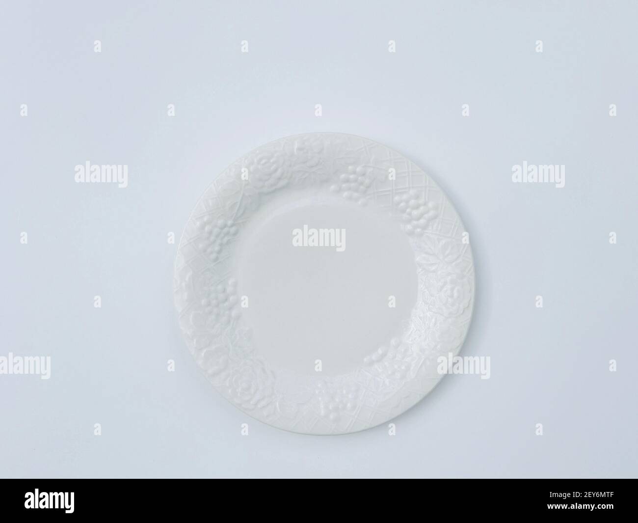 A top view of a white decorative plate isolated on white background ...