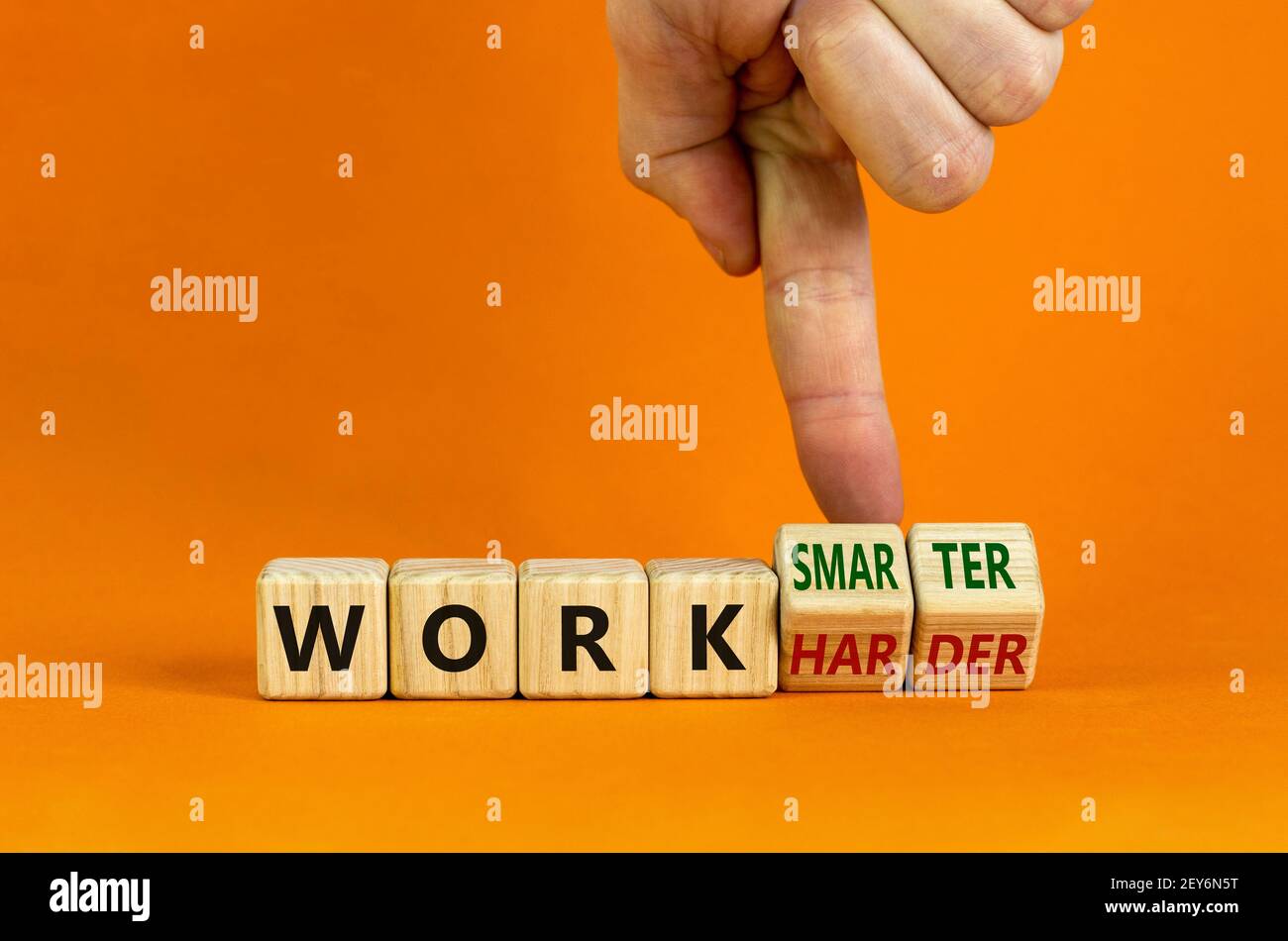 Work harder or smarter symbol. Businessman turns wooden cubes and ...
