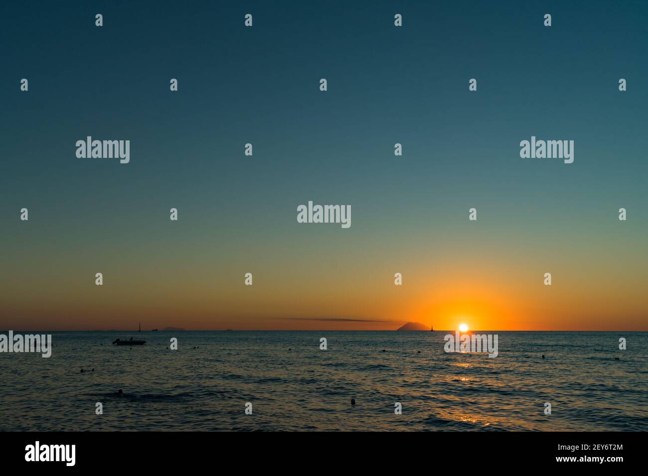 A mesmerizing scenery of sunset at Tropea beach with Stromboli island ...