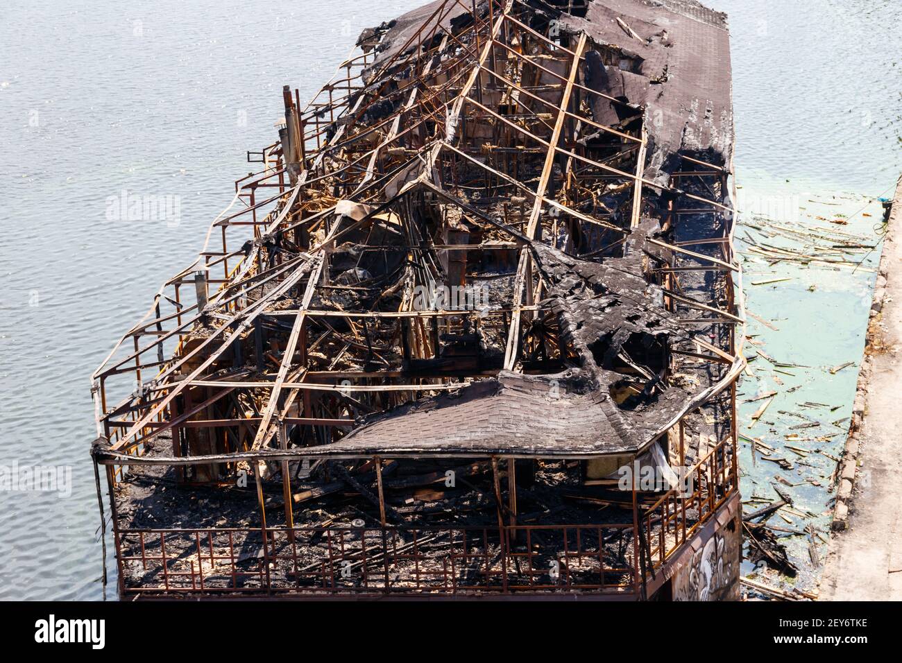 Burned ship in the water Stock Photo - Alamy