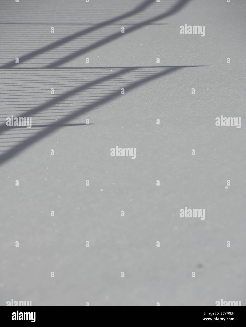 exterior hand railing shadows cast on fresh fallen snow in winter ...