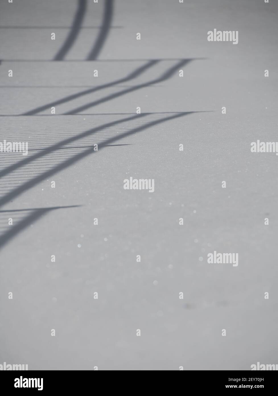 exterior hand railing shadows cast on fresh fallen snow in winter ...