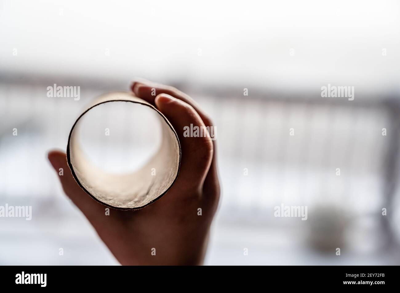 Child using imagingation to play with a cardboard tube as a telescope ...