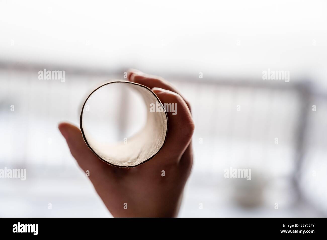 Child using imagingation to play with a cardboard tube as a telescope ...