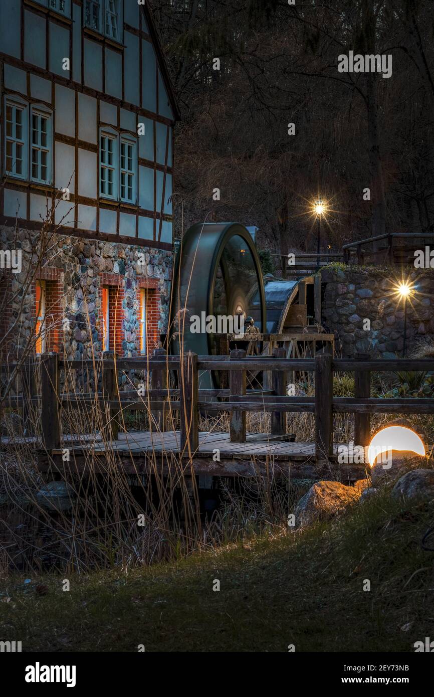 A beautiful view of a watermill near the beautiful building in the ...