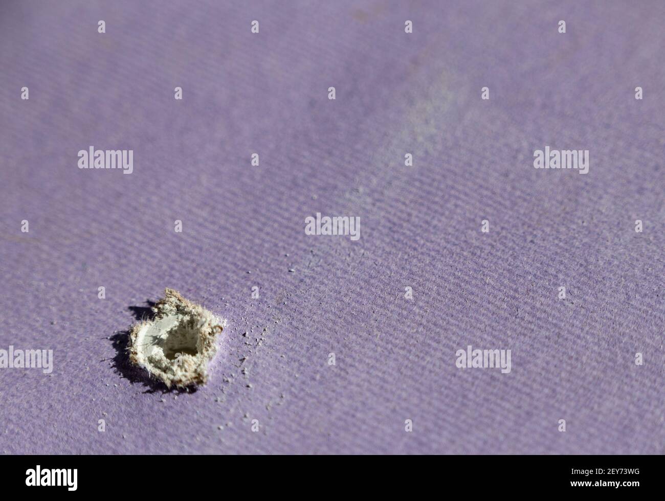 Drywall damage caused by removing a screw and leaving a hole Stock ...