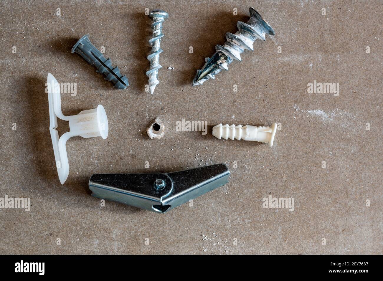 Various drywall anchors used in construction to hang objects on walls ...