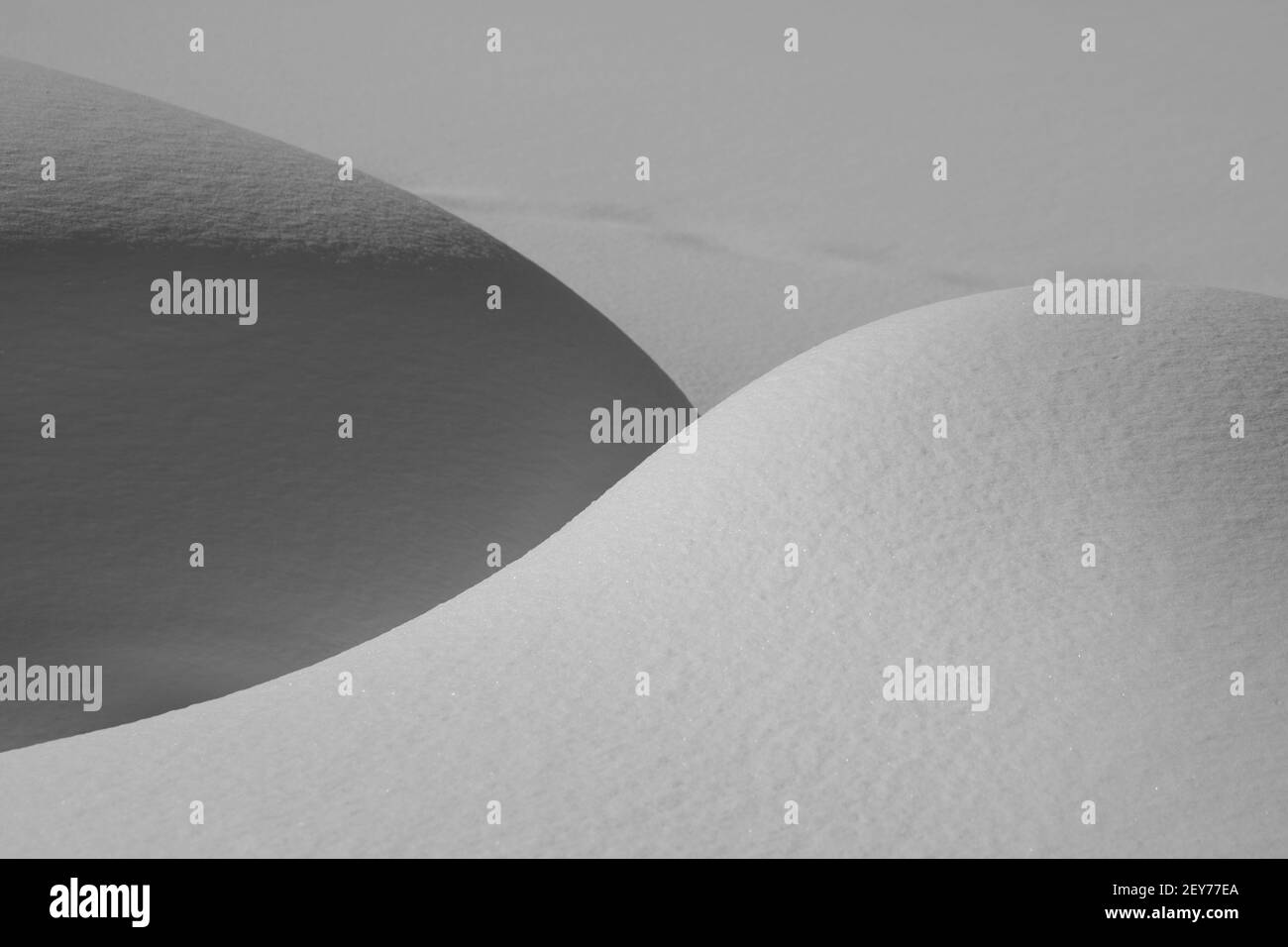 close up of two mounds of fresh snow symmetrical in shape one in ...