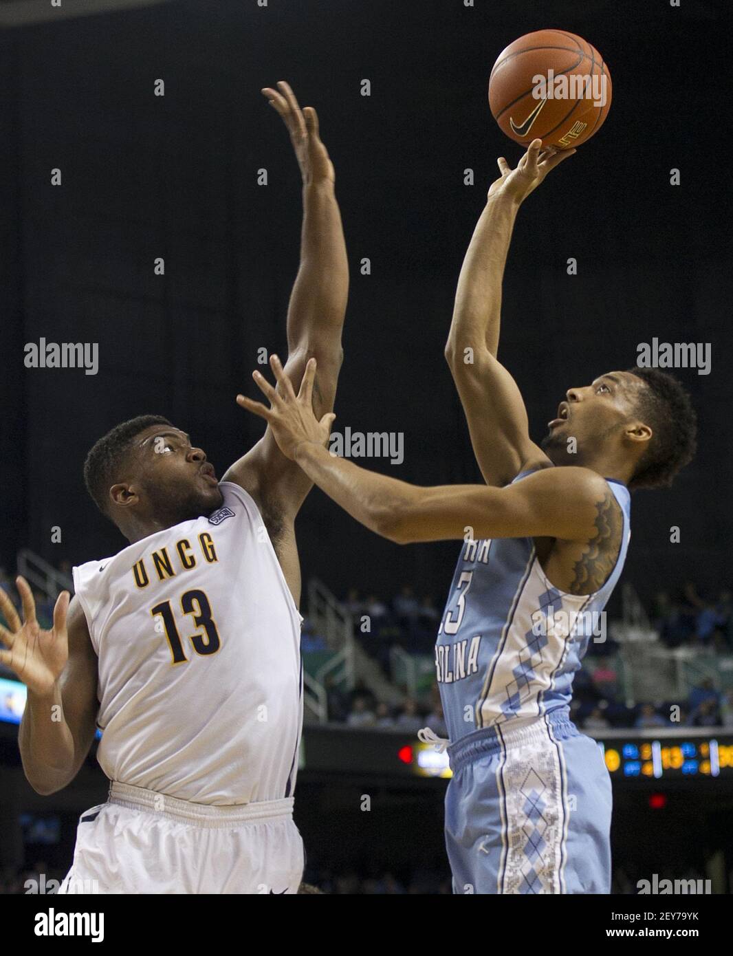 North Carolina's J.P. Tokoto, right, puts up a shot against UNC ...