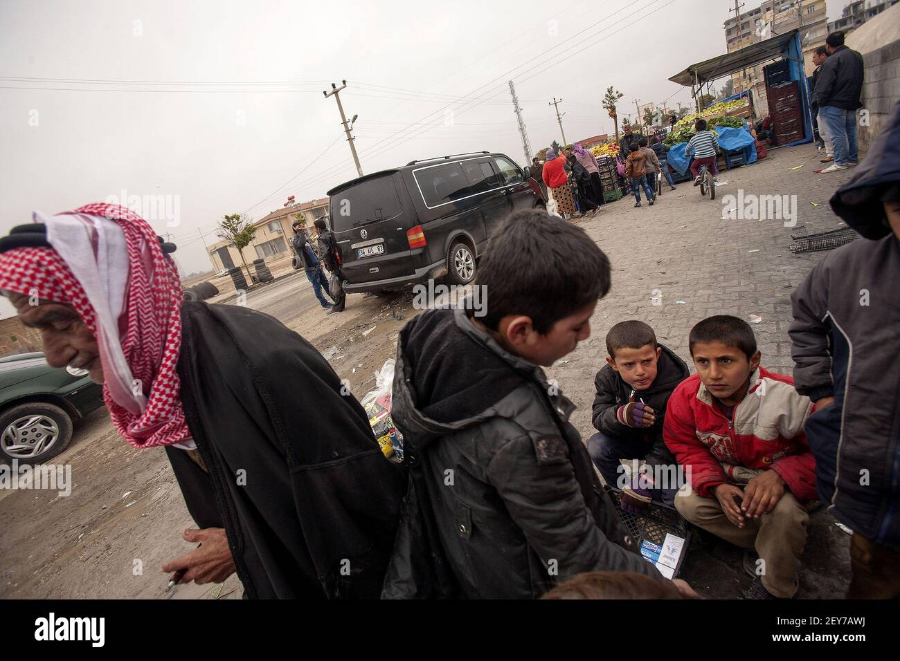 Kurdish children sell snacks and gum on the street near the camp in ...